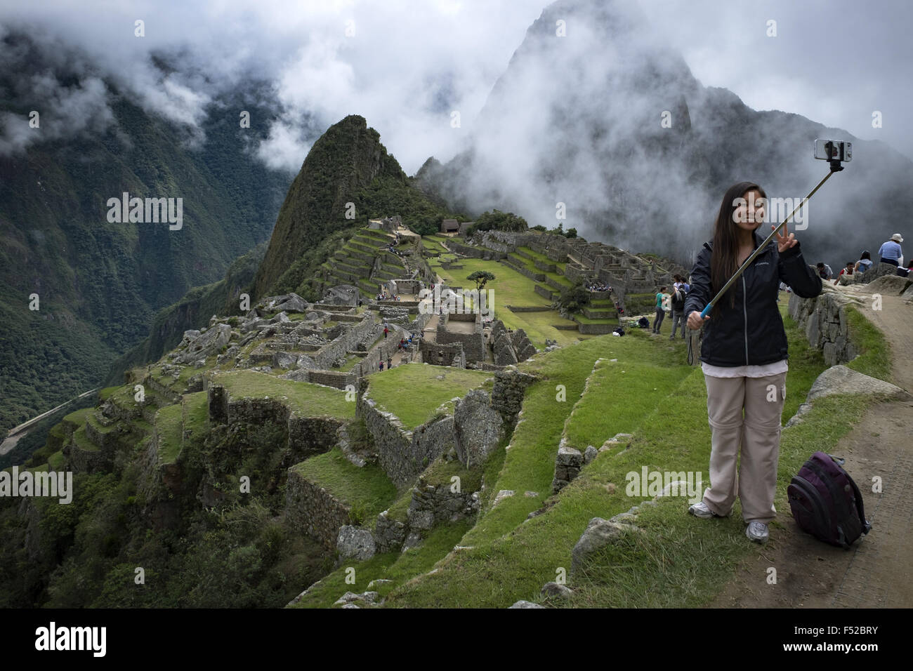 A tourists taking pictures in the city of Machu Picchu Stock Photo - Alamy