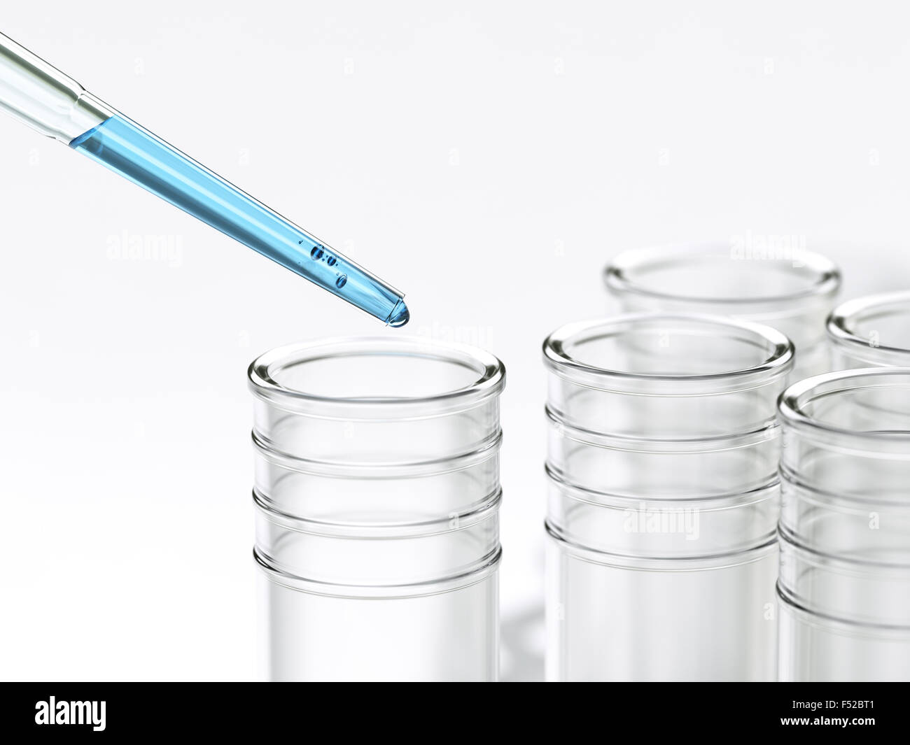 Dropping blue liquid in test-tubes isolated on white Stock Photo - Alamy