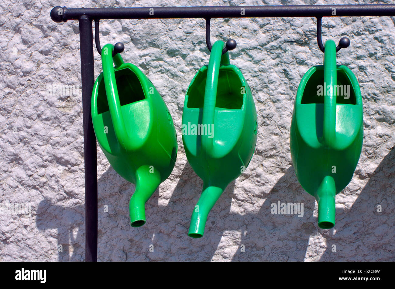 Plastic Watering Can Hanging Stock Photo - Alamy