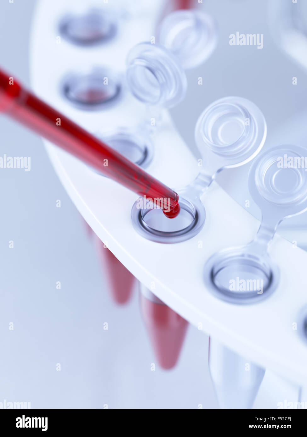 Dropping blood sample in test-tube close-up Stock Photo - Alamy