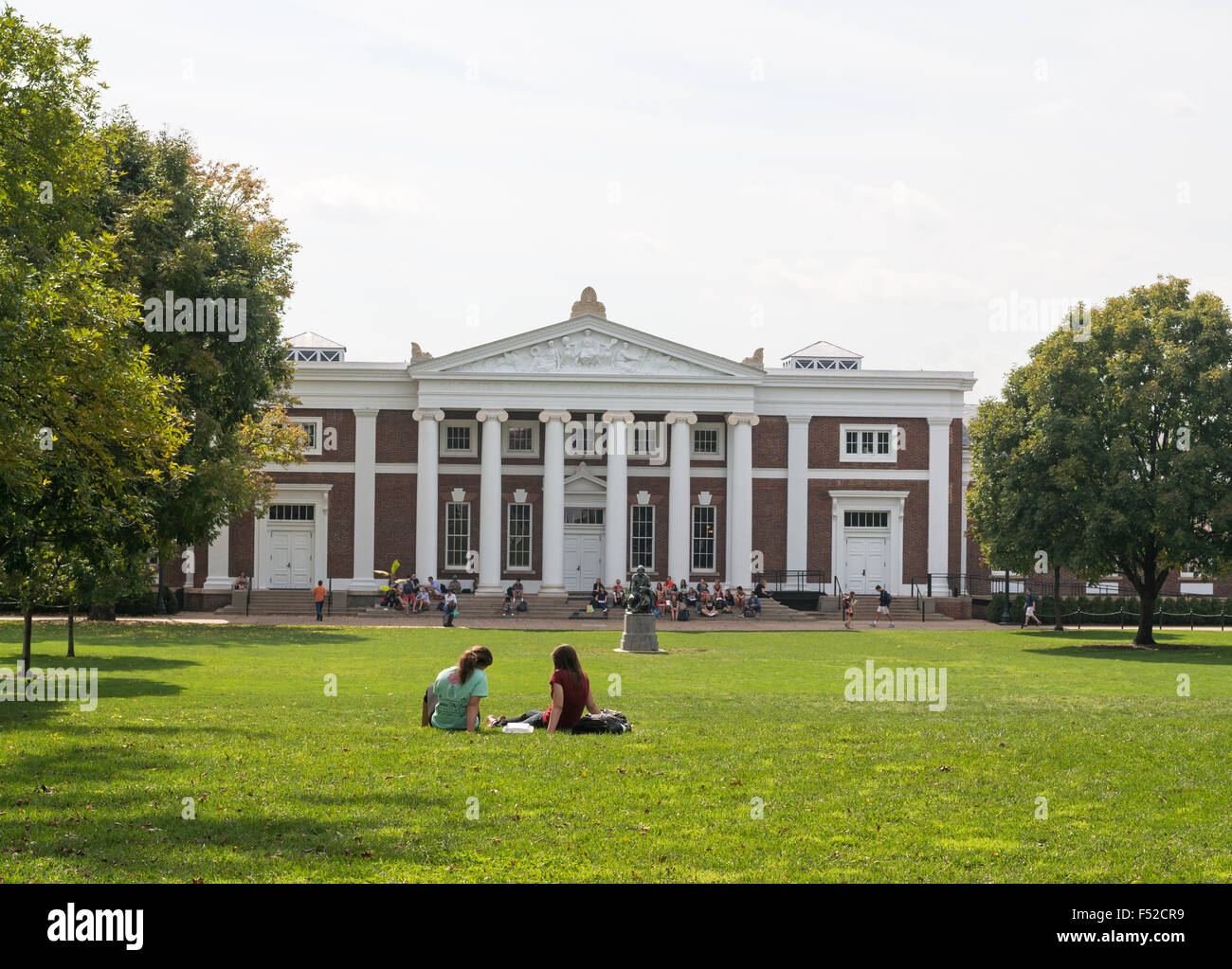 Two female students sitting on South Lawn in front of Old Cabell Hall ...