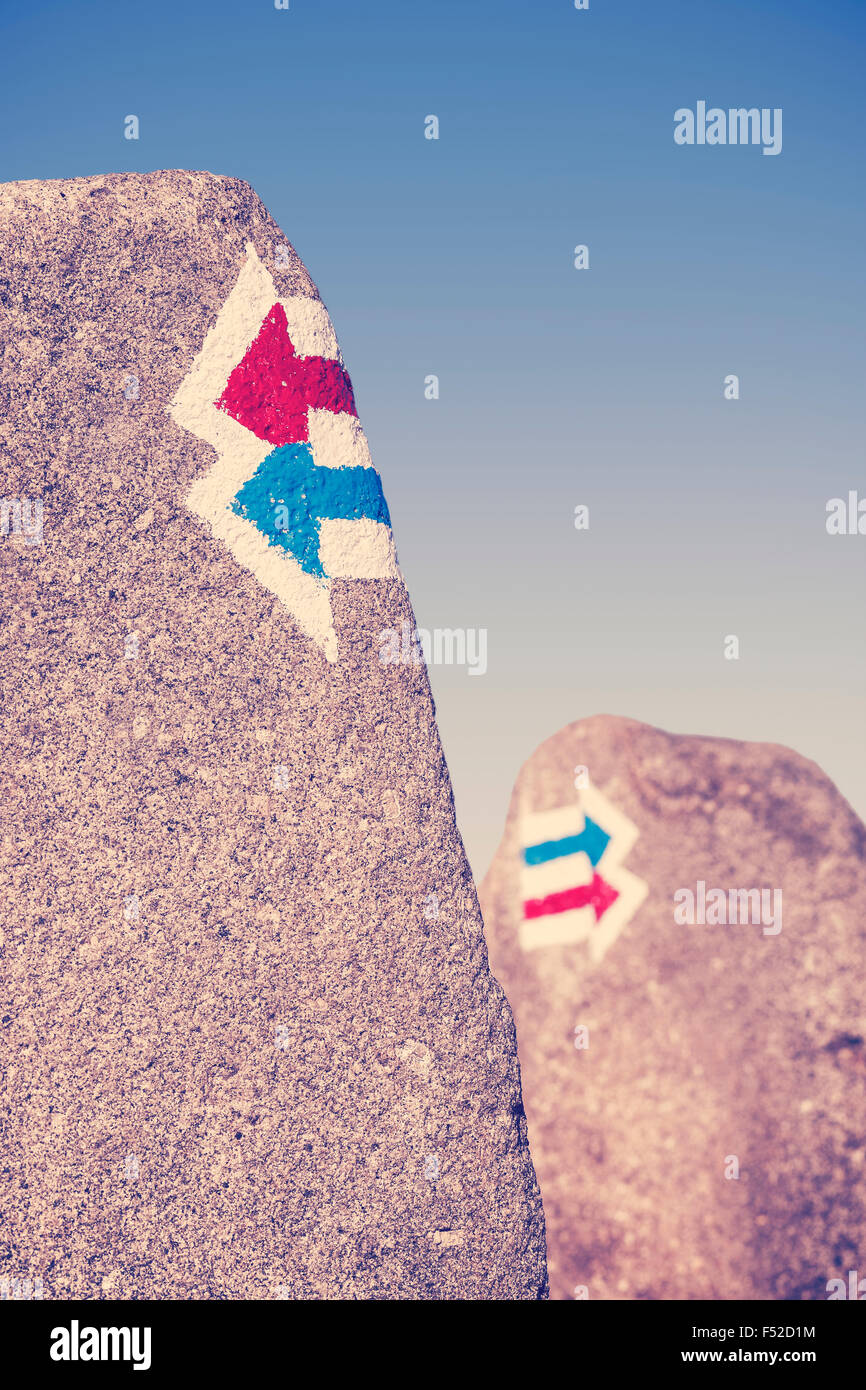 Retro toned trail signs painted on rock, choice or dilemma concept ...