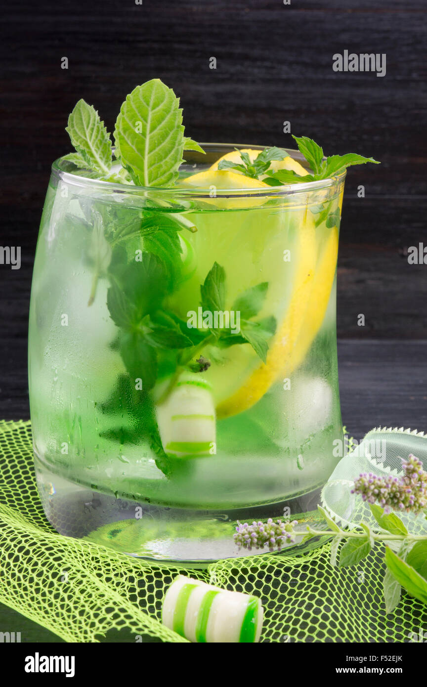 Homemade mojito cocktail in a crooked glass with mint bonbons Stock ...
