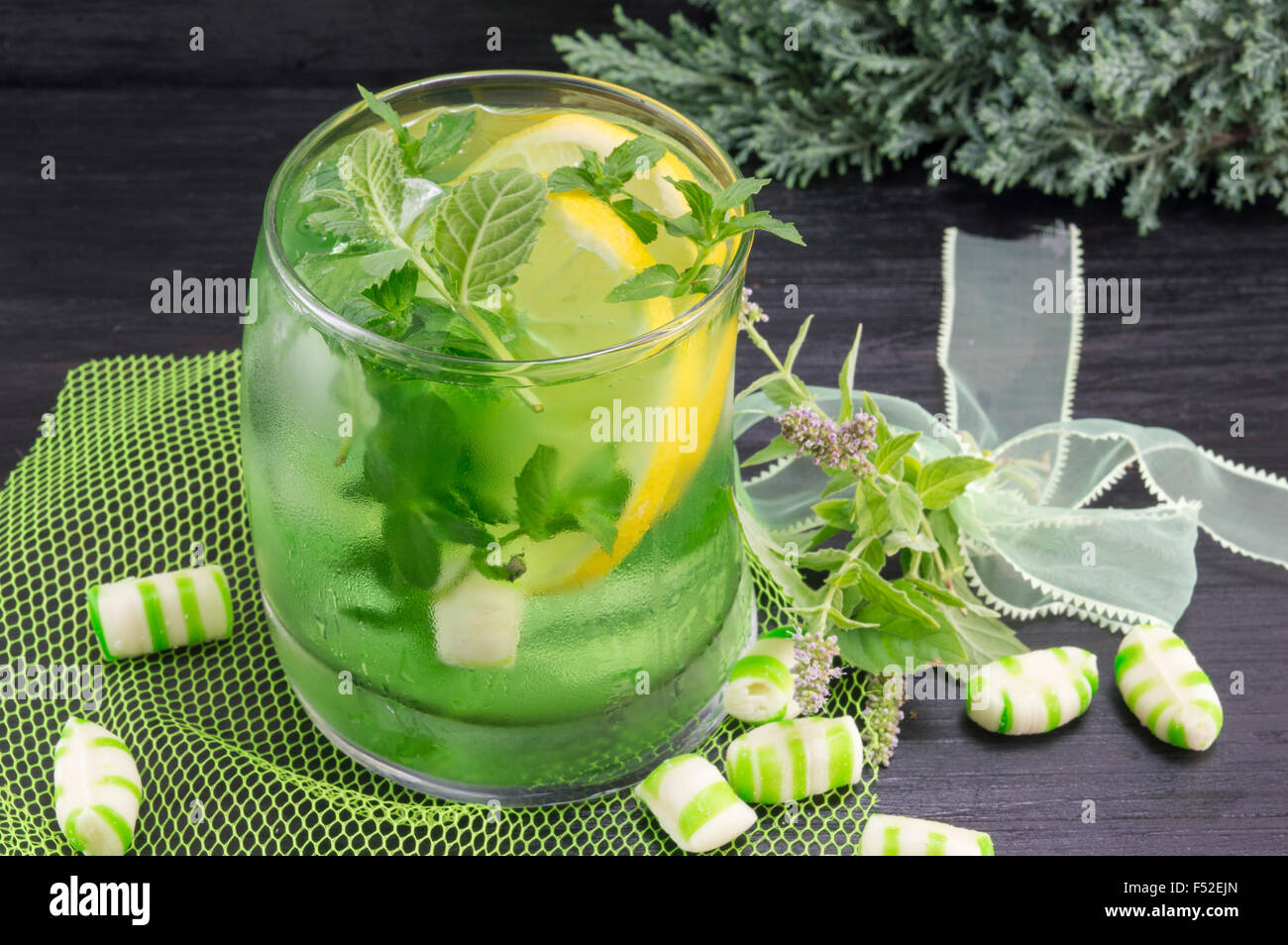 Homemade mojito cocktail in a crooked glass with mint bonbons Stock ...