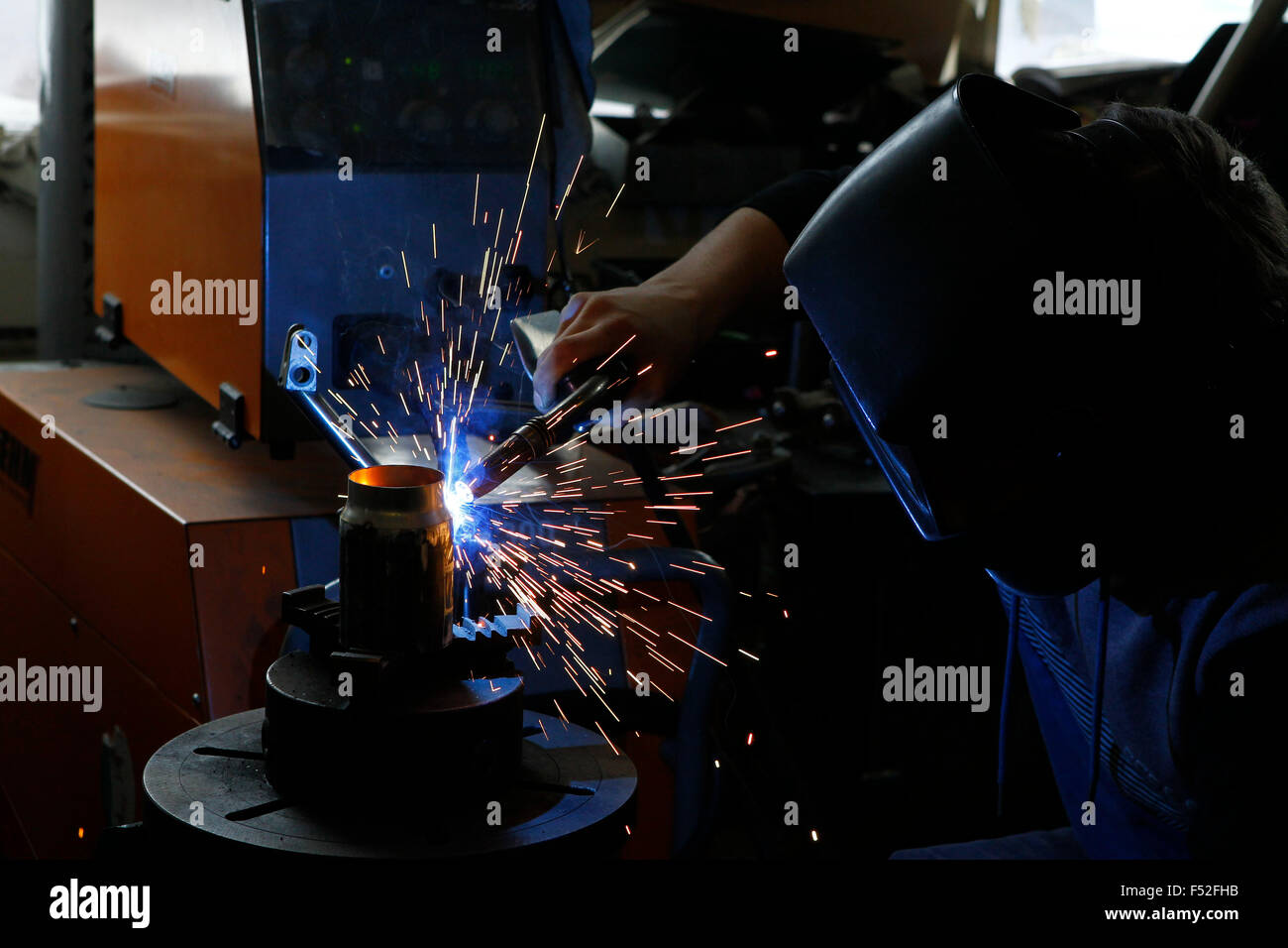 Man welding workpiece, workshop, flying sparks Stock Photo - Alamy