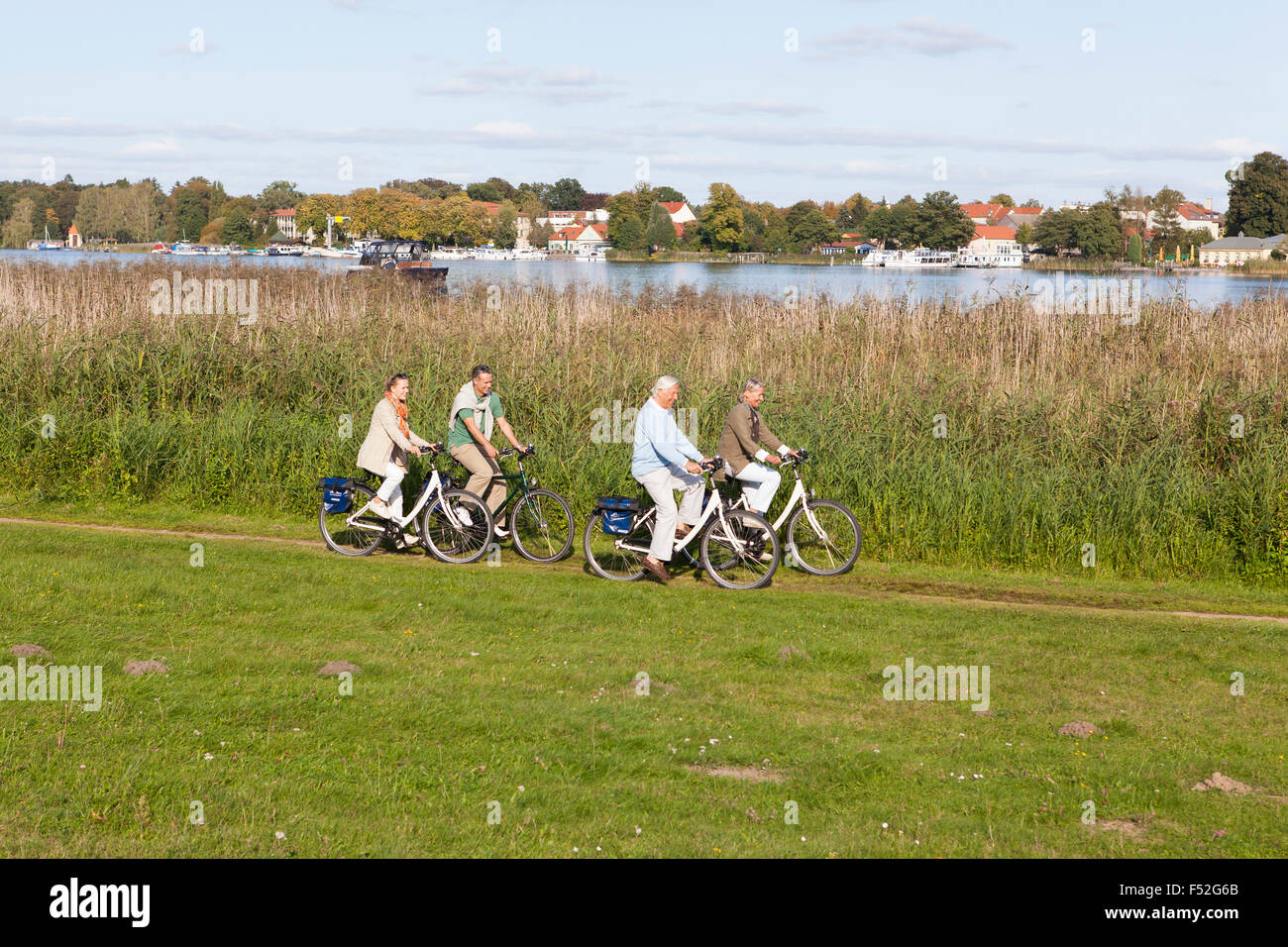 Two couples, lakeside, bicycle excursion Stock Photo - Alamy