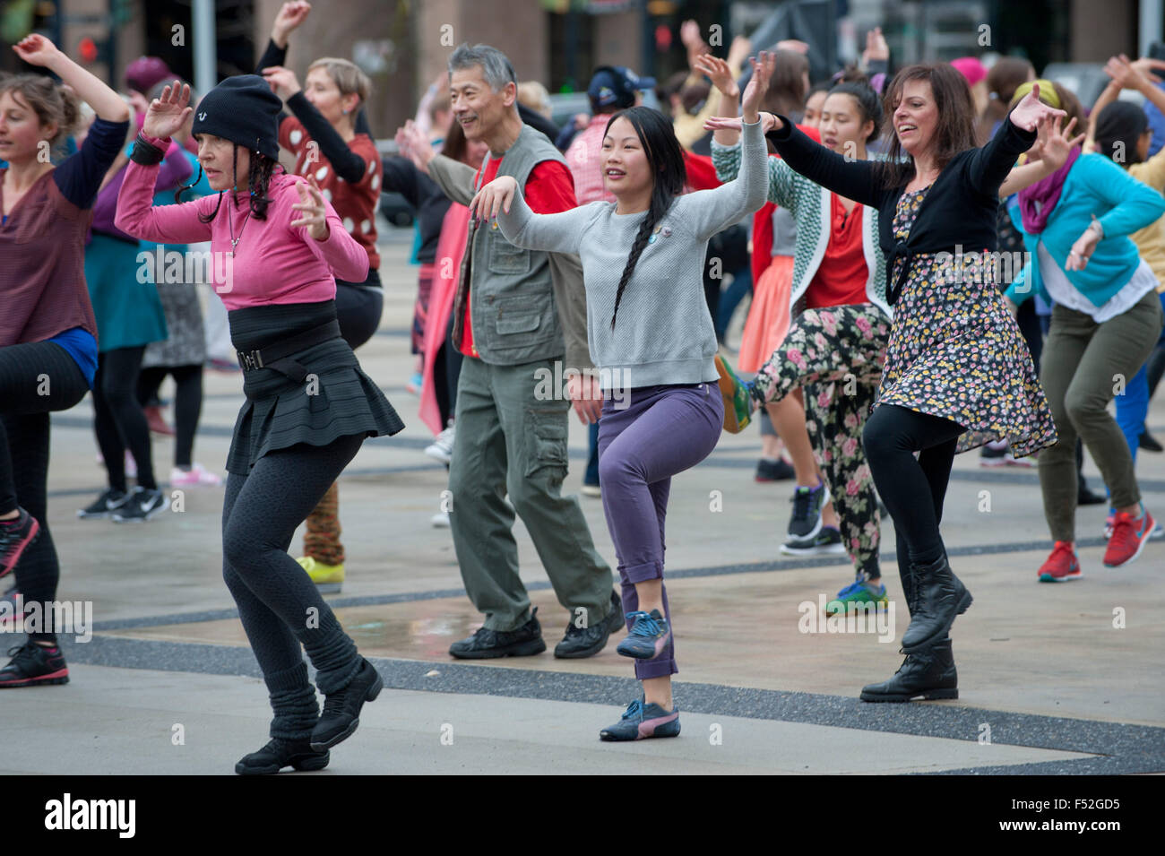 Many people dance in the Queen Elizabeth Theatre square in downtown of ...