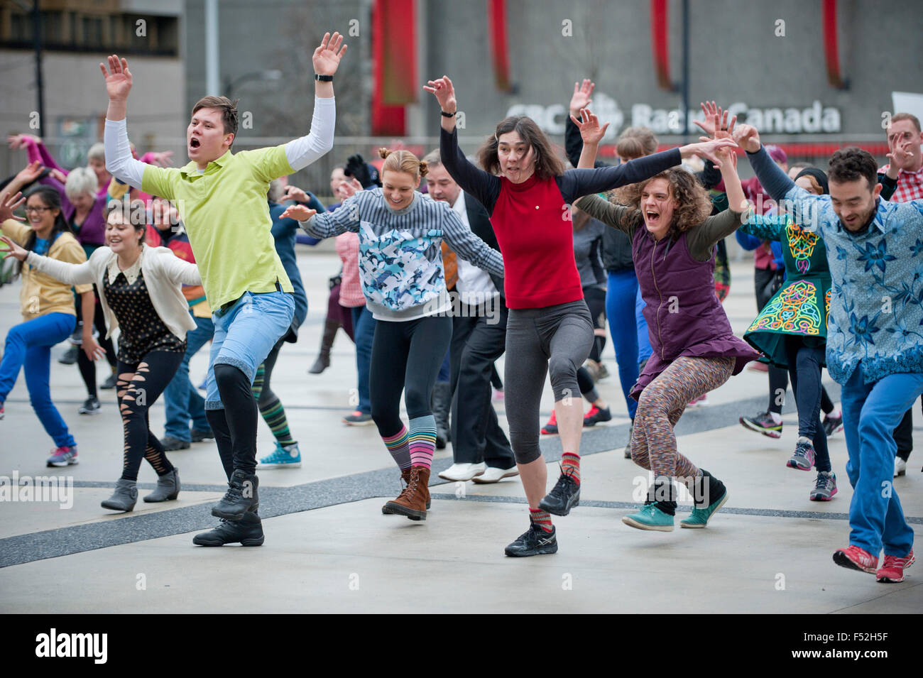 Many people dance in the Queen Elizabeth Theatre square in downtown of ...