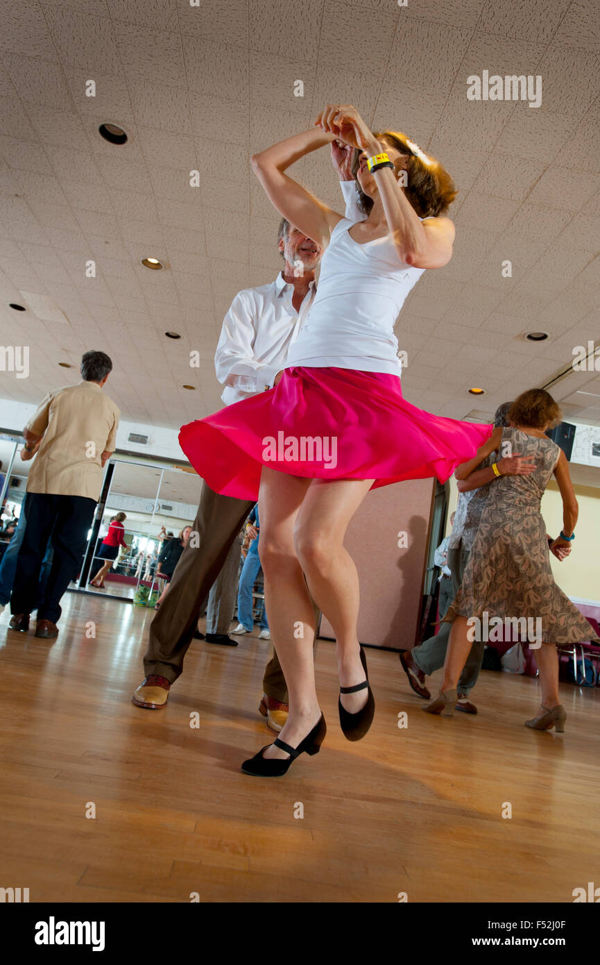Older couples ballroom dancing doing the lindy hop and jitterbug in a ...