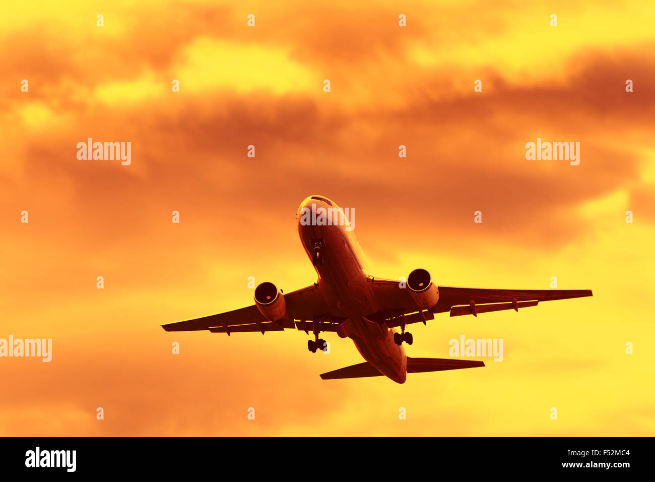 Jet Airplane In Flight At Sunset Time Stock Photo - Alamy