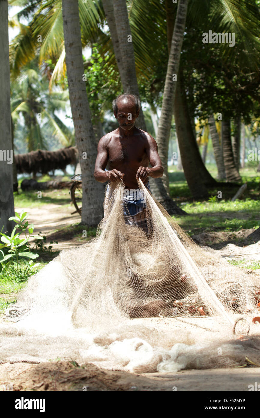 a man waving fishnet in india Stock Photo - Alamy