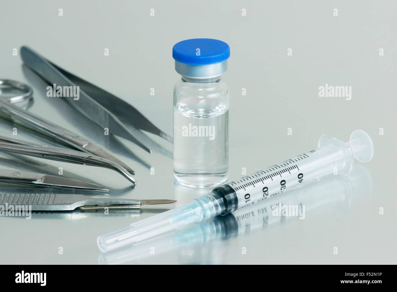 Syringe, vial and surgical instruments on surgical tray Stock Photo - Alamy