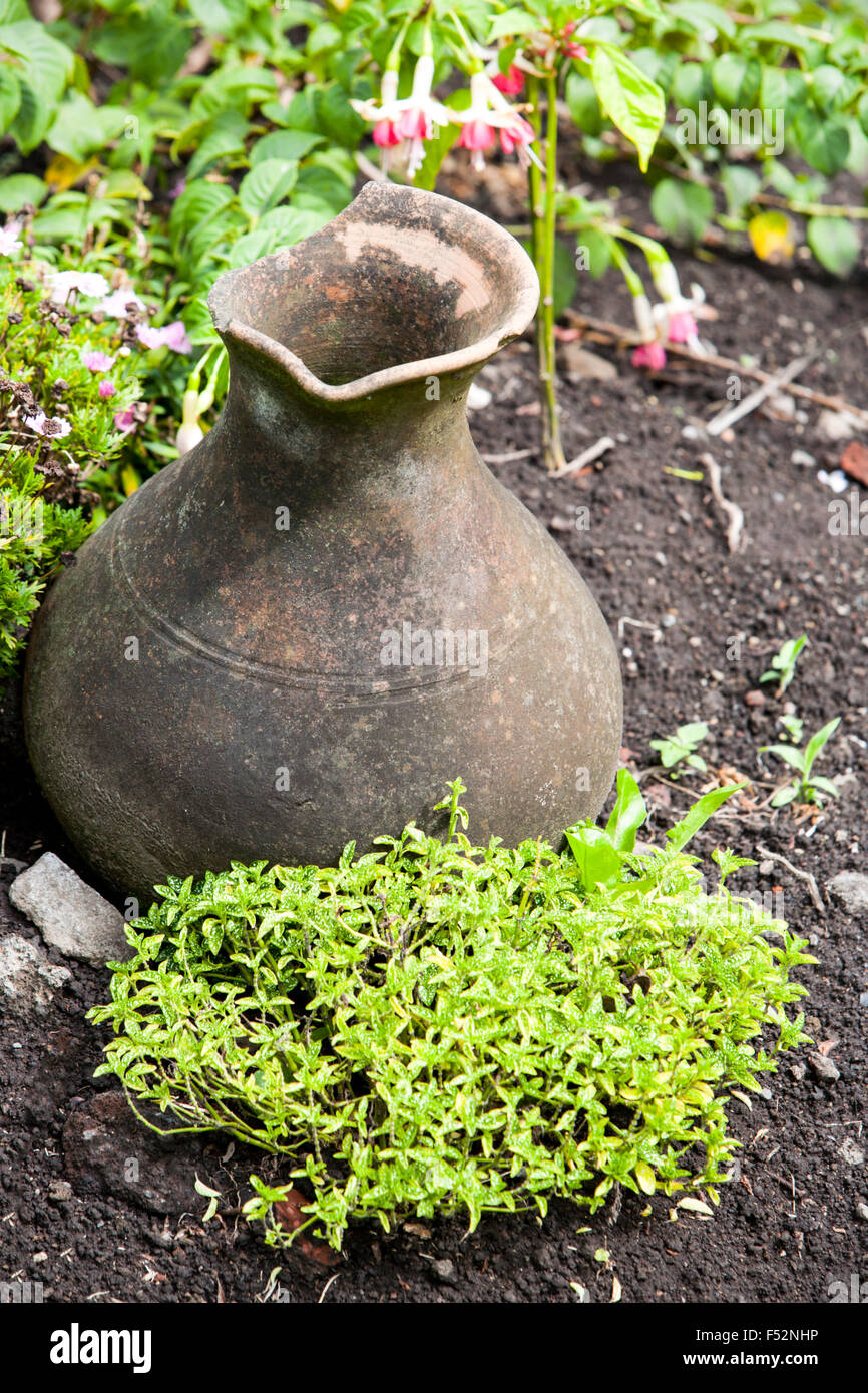 Clay Pot Used As Design Detail In A Colorful Garden Stock Photo - Alamy