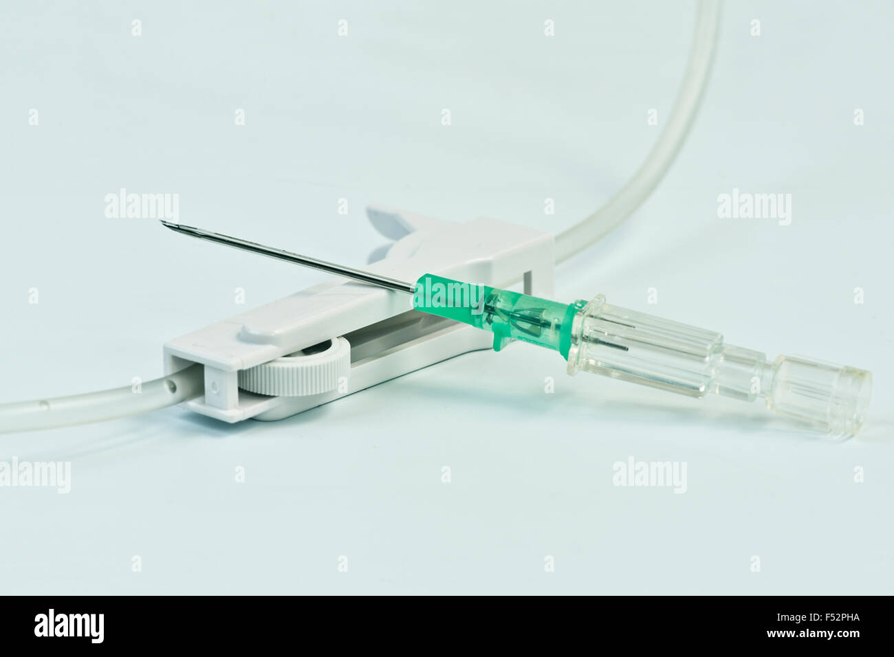 IV catheter with flow rate adjuster on neutral background Stock Photo ...