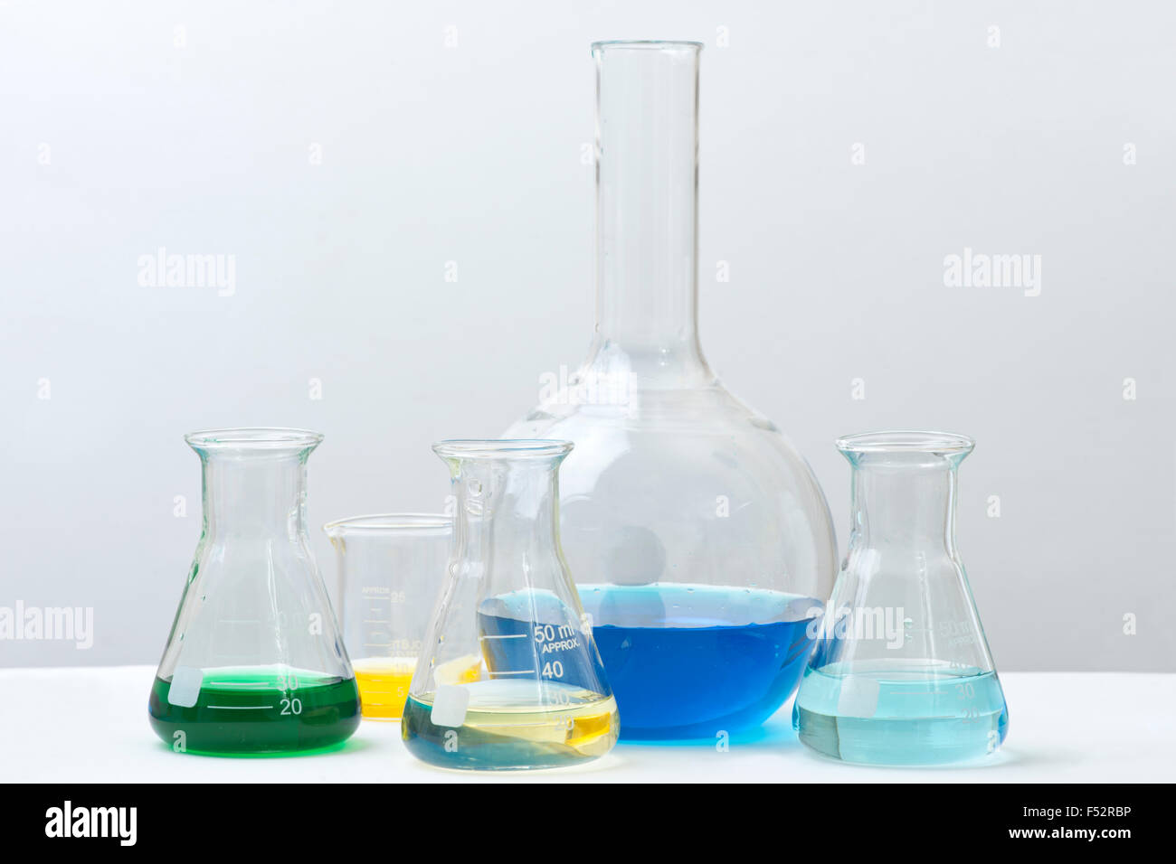 Different colored lchemical reagents in laboratory glassware Stock ...