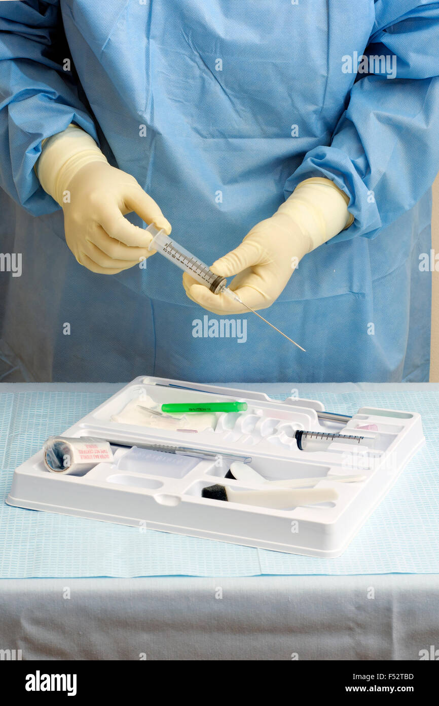 Nurse prepares large syringe prior to thoracostomy surgery Stock Photo ...