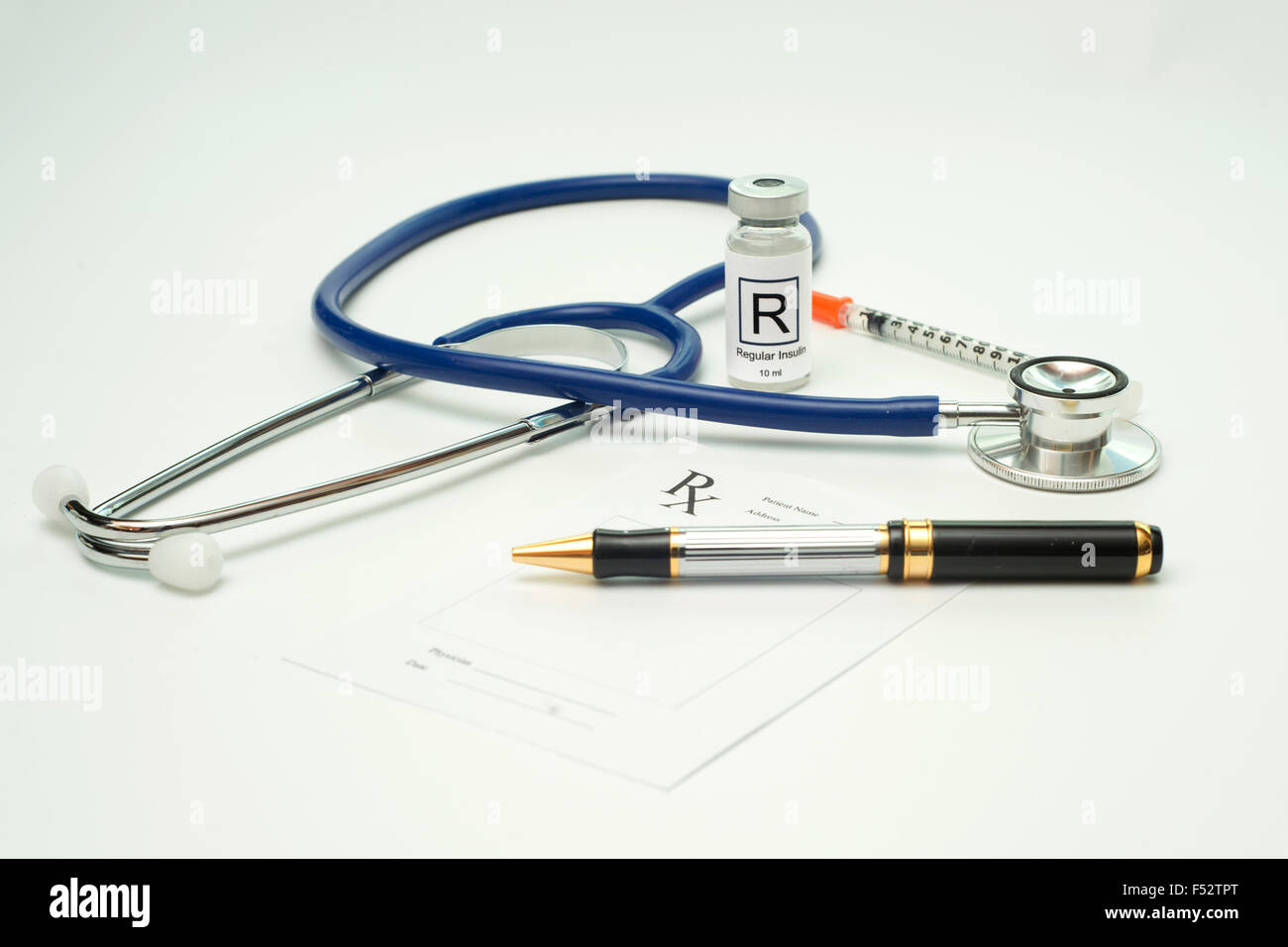 Regular insulin vial with prescription, pen, syringe and stethoscope ...