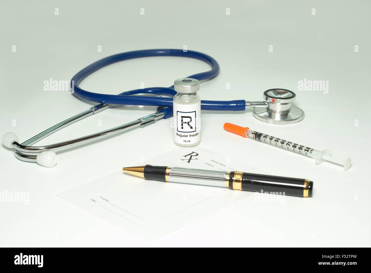 Regular insulin vial with prescription, pen, syringe and stethoscope ...