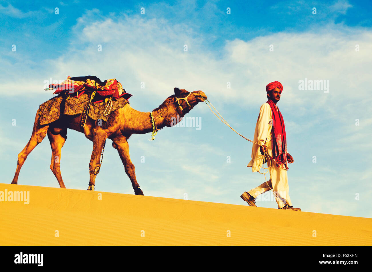 Indigenous Indian man walking desert camel Concept Stock Photo - Alamy