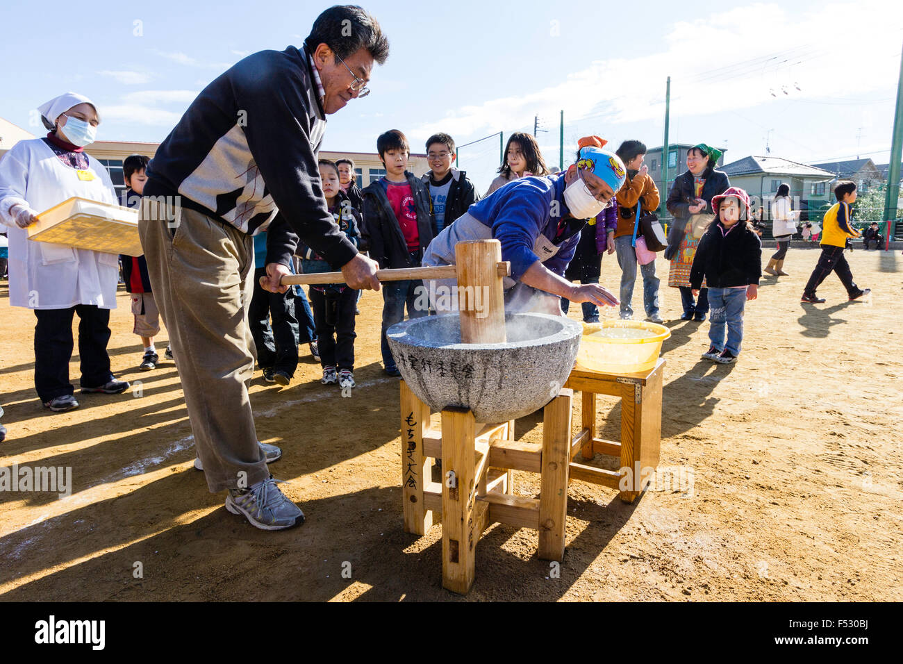 Japan. Omochi, winter rice bashing festival. Man holding with both ...