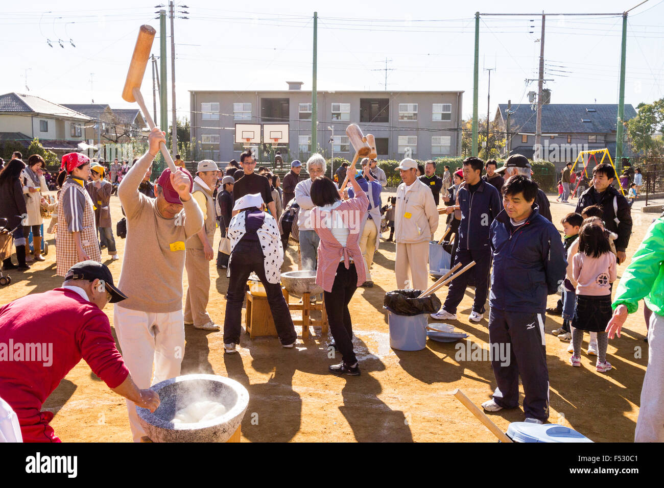 Japan. Omochi, winter rice bashing festival. Man holding with both ...