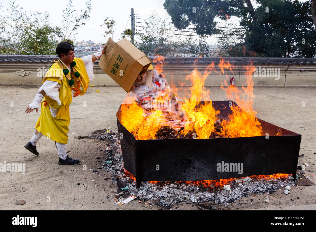 Japan, Nishinomiya, Mondo Yakujin Buddhist Temple. Priest in yellow ...