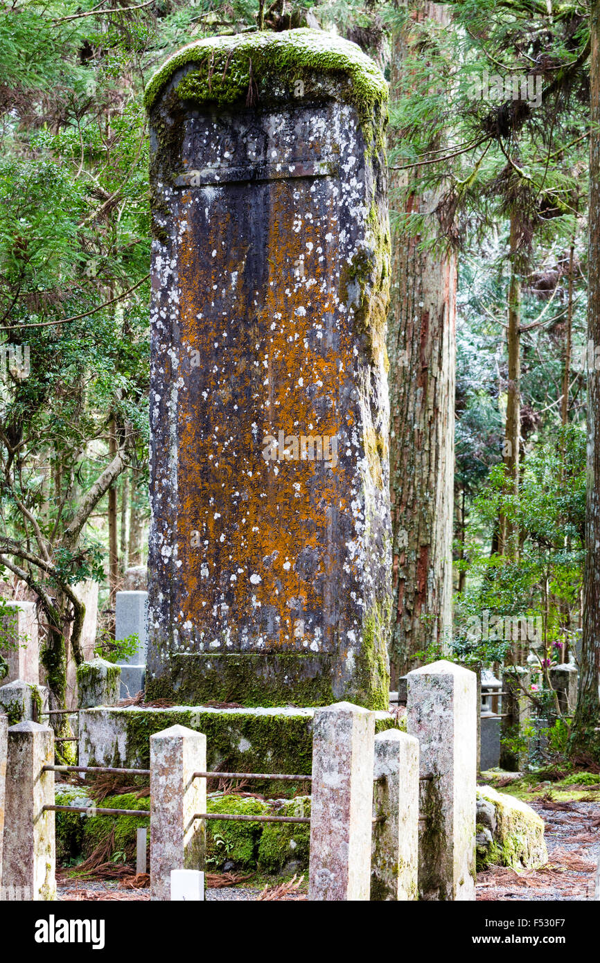Japan, Koyasan, Okunoin cemetery. Grave memorial stone with green and ...