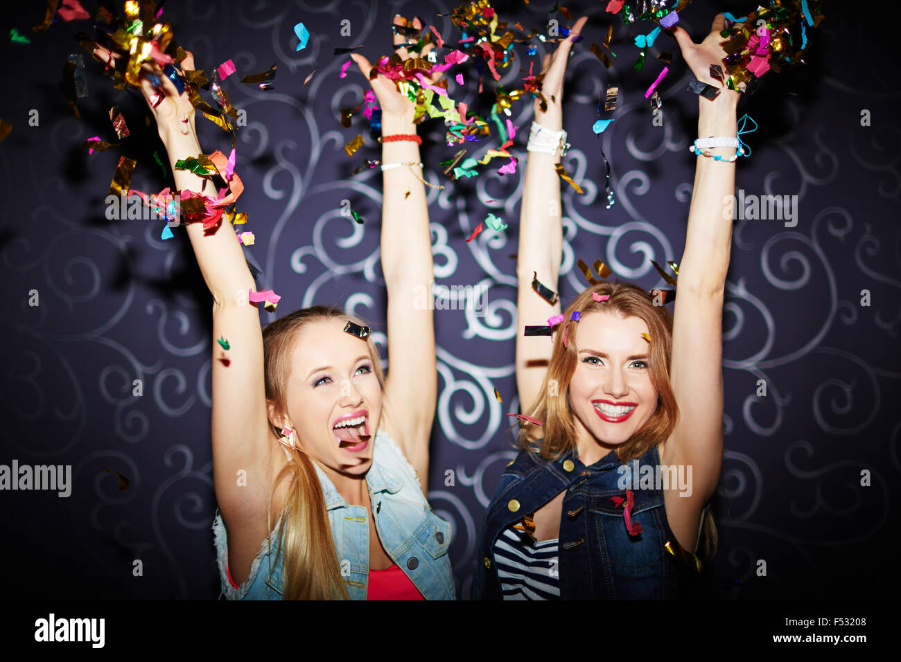 Two ecstatic girls having fun in night club Stock Photo - Alamy