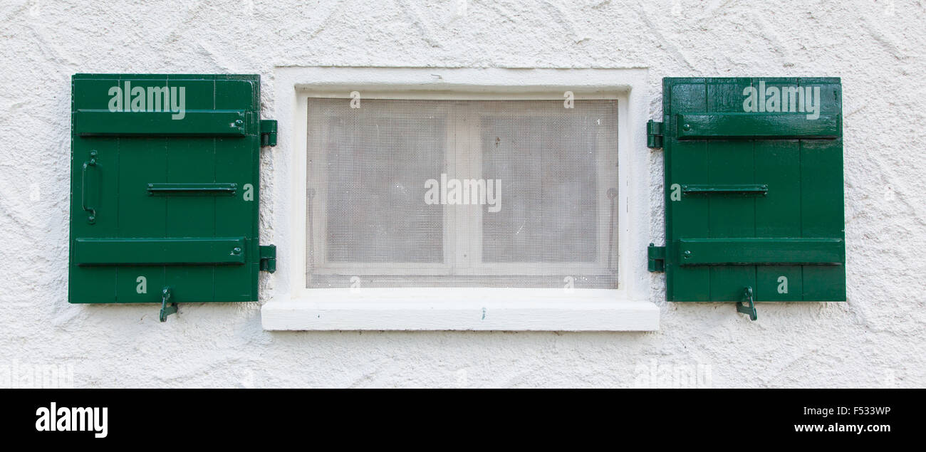 Small window with open wooden green shutters Stock Photo - Alamy