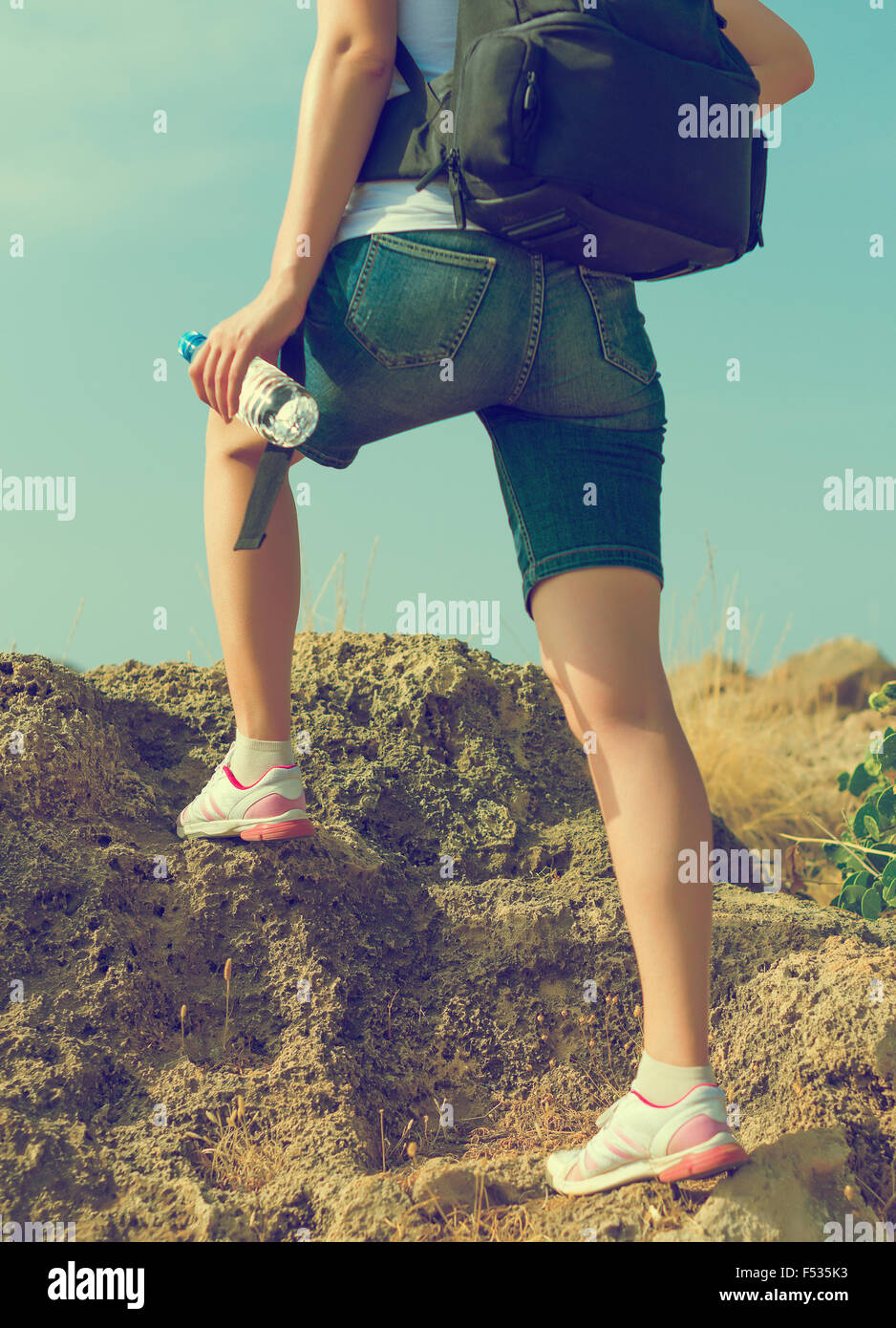Female hiker walking with backpack. View from the back Stock Photo - Alamy