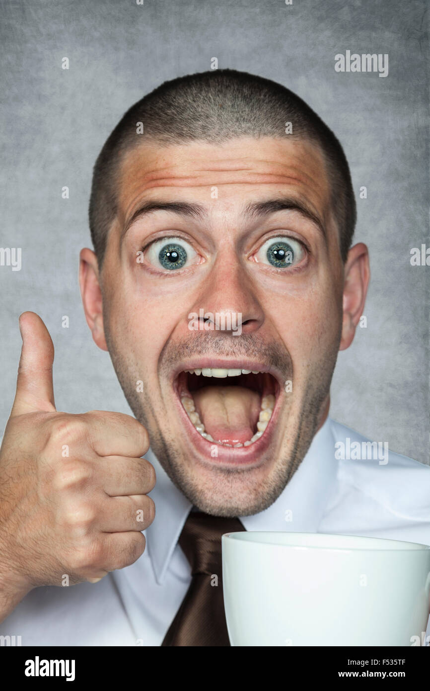 happy businessman with pop-eyed, showing thumbs up for morning coffee ...
