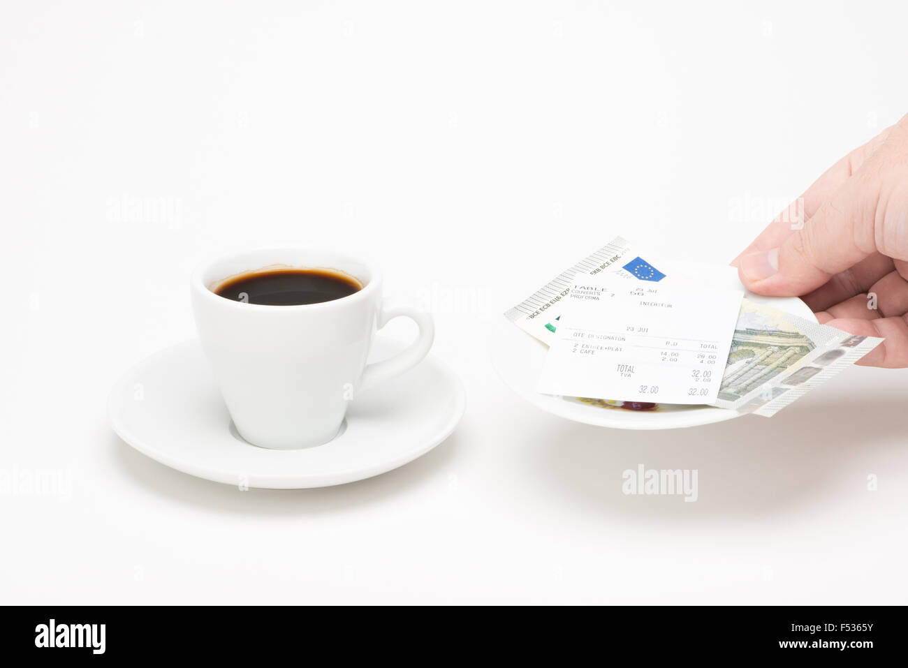Cup of coffee with bill on white background Stock Photo - Alamy