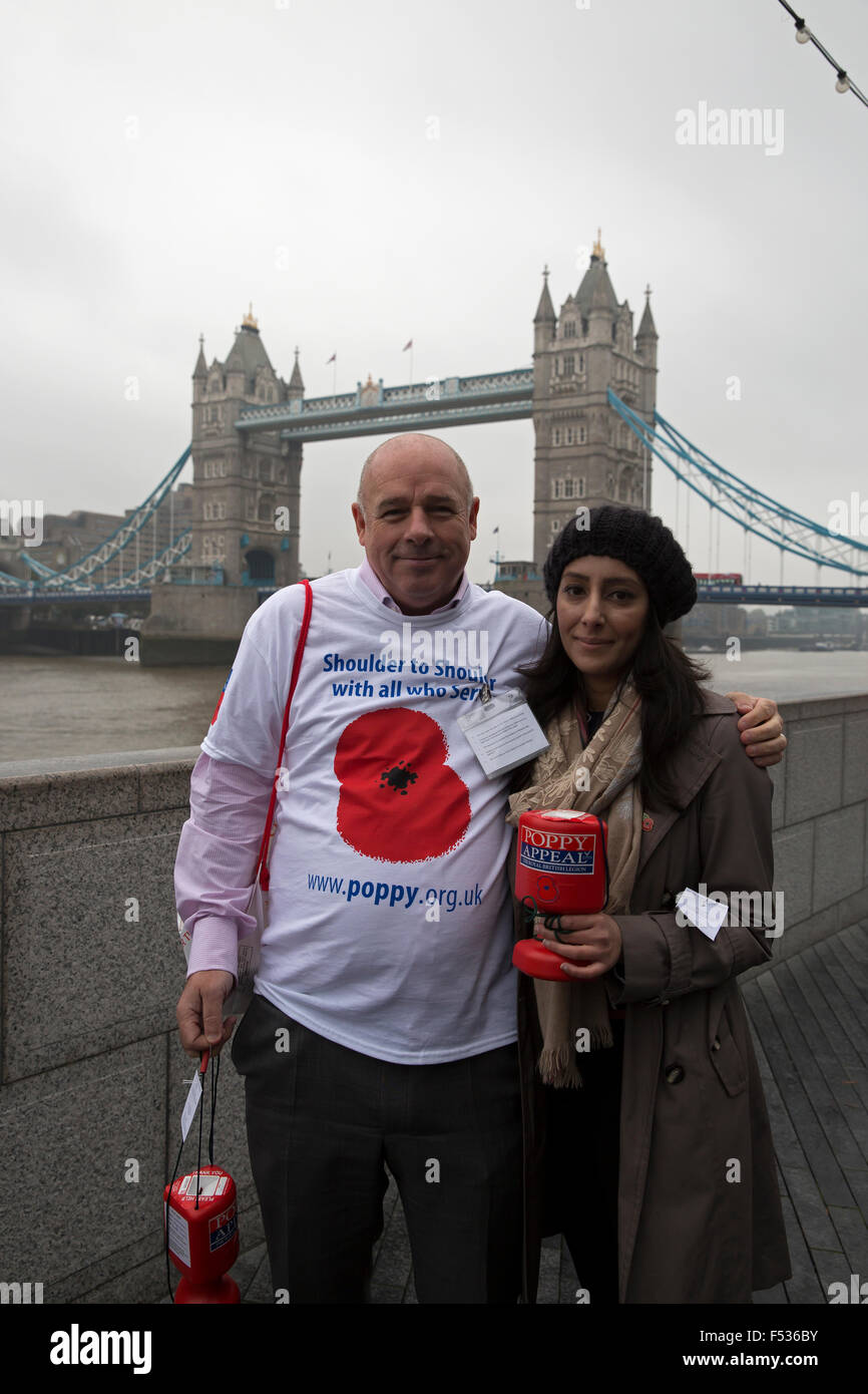 London, UK. 27th Oct, 2015. Poppy collectors stand by Tower Bridge in ...