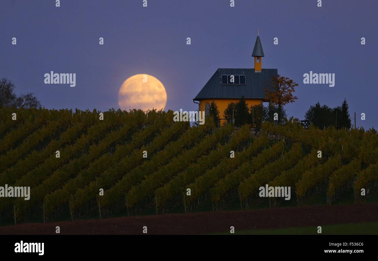 Bergtheim, Germany. 26th Oct, 2015. The full moon rises behind a small ...