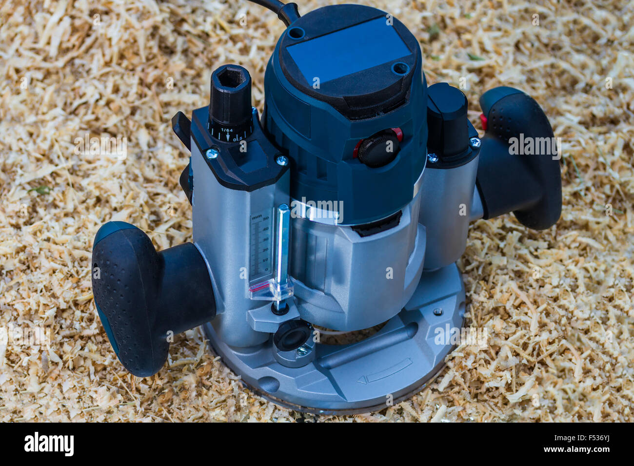 variable speed plunge router on sawdust background Stock Photo - Alamy