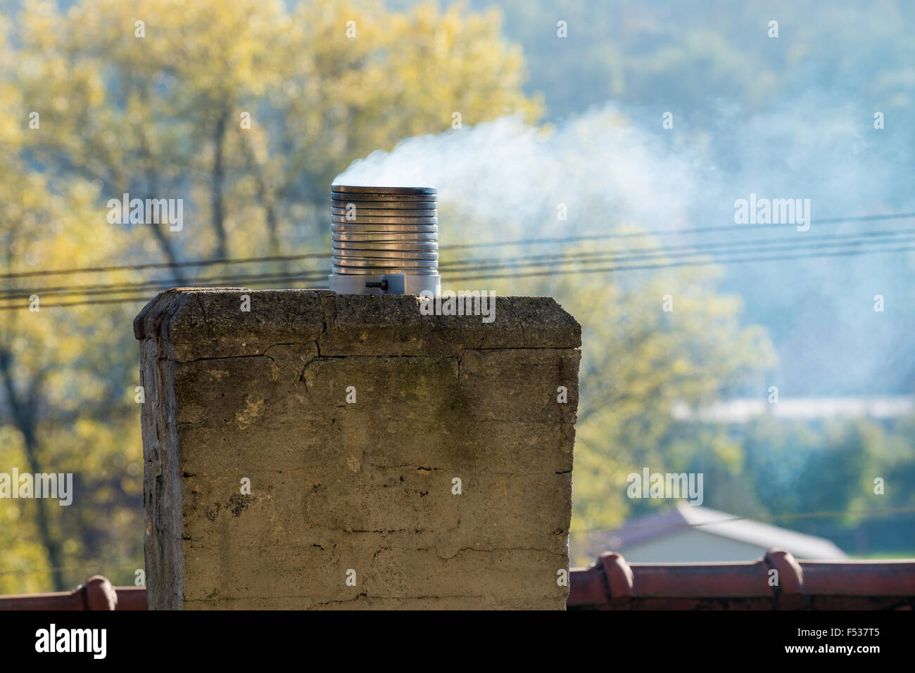 Smoke coming from chimney in a house Stock Photo - Alamy