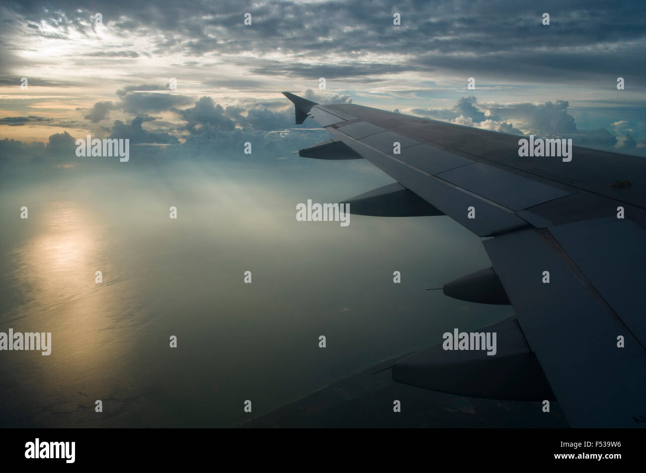Wing of airplane and at sunset Stock Photo - Alamy