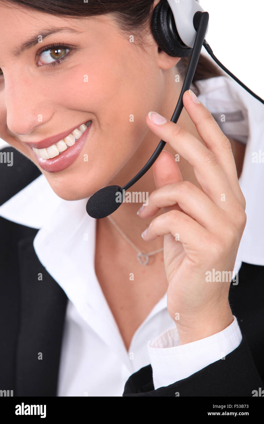 Young woman wearing telephone head set Stock Photo - Alamy