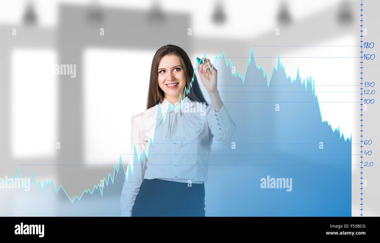 Beautiful business woman stands behind the big graph on the office background Stock Photo - Alamy