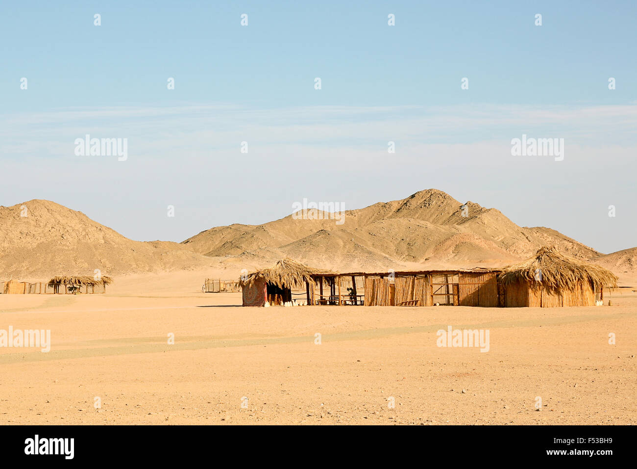 Traditional rural African reed and thatch hut and mountain landscape on ...