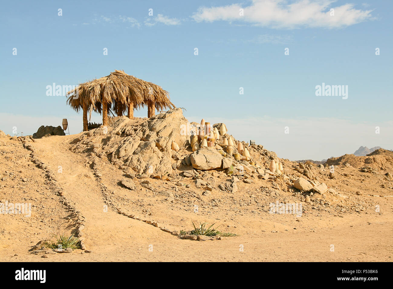 Traditional rural African reed and thatch hut and mountain landscape on ...
