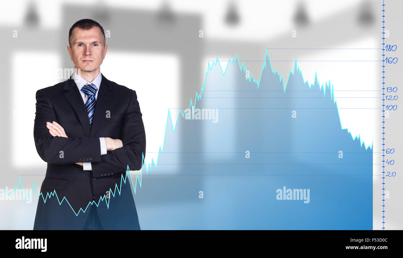 Businessman stands behind the big graph on the office background Stock ...