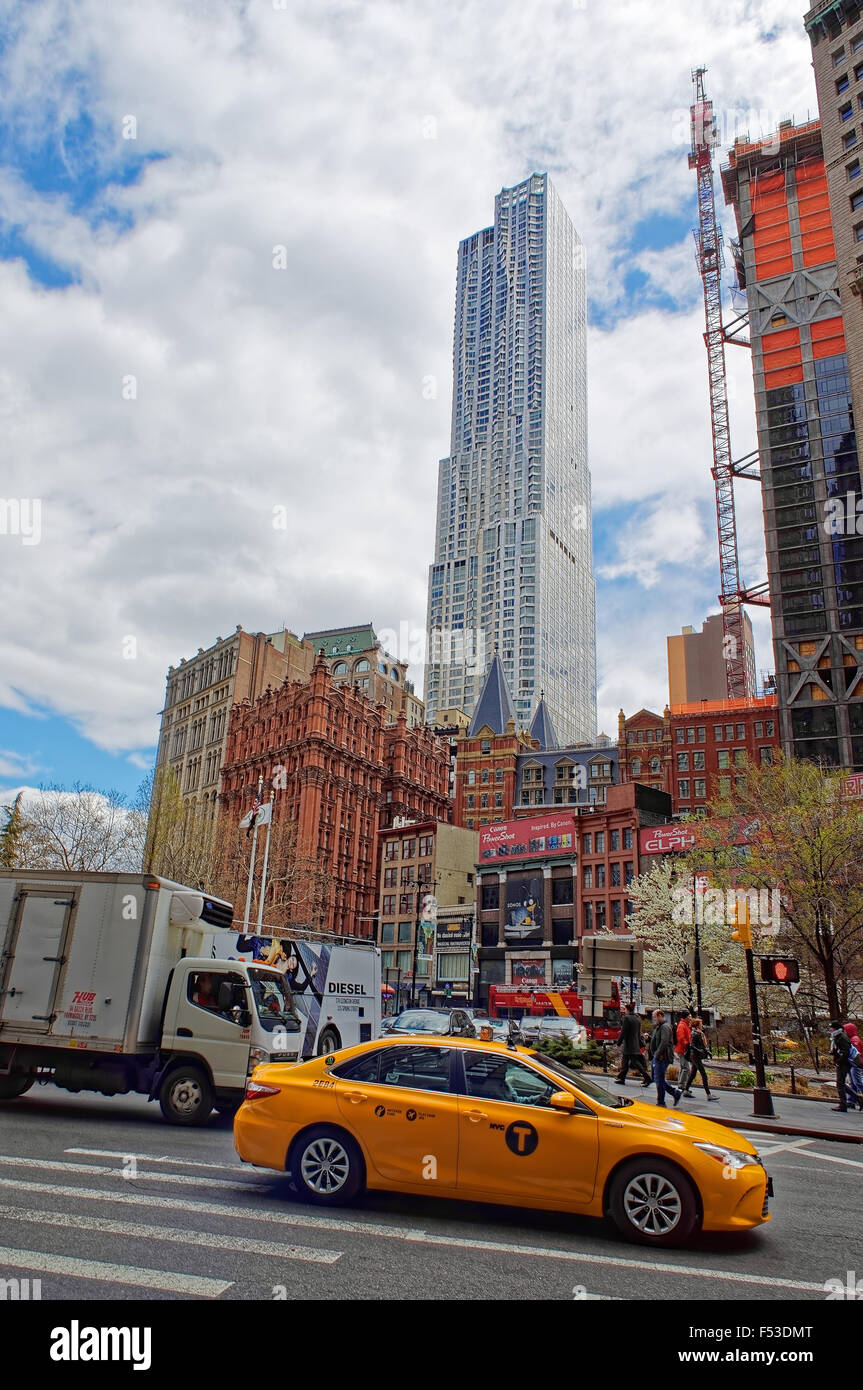 Typical New York City street view with a yellow taxi, passing by pedestrians, ongoing ...