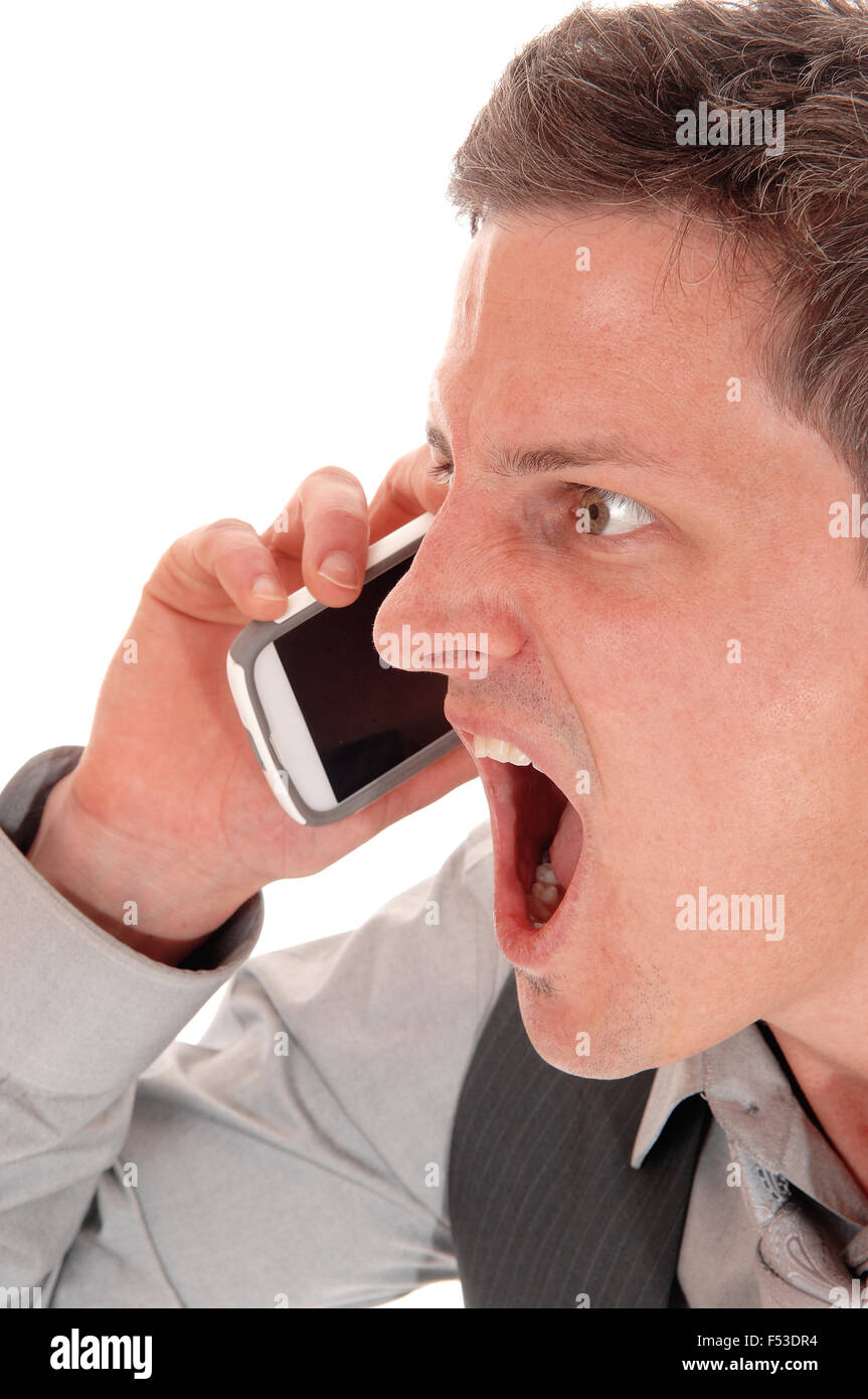 A closeup picture of a young man screaming in his cell phone, with his ...