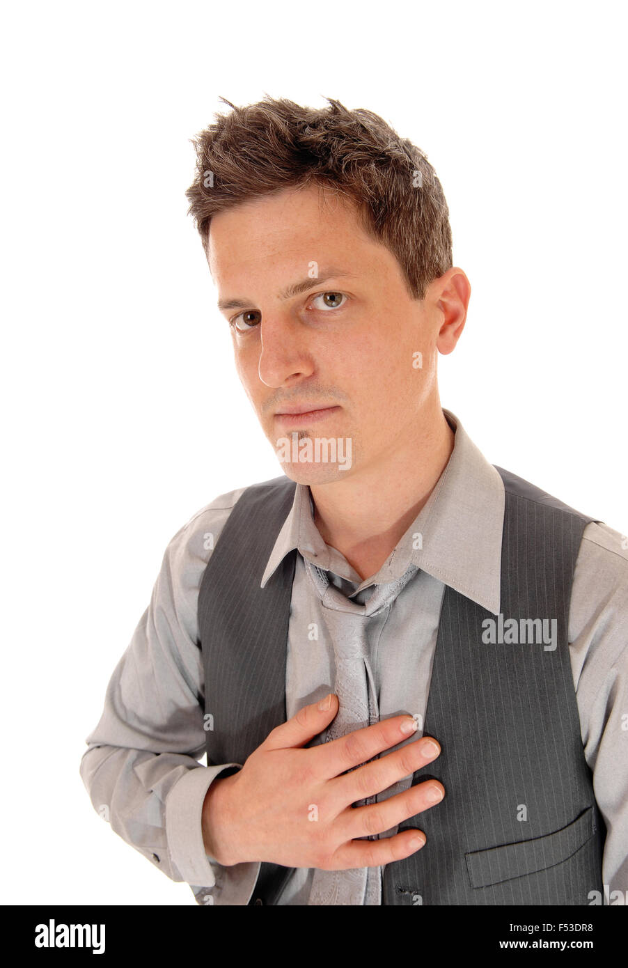 A portrait picture of a handsome young man with one hand on his chest ...