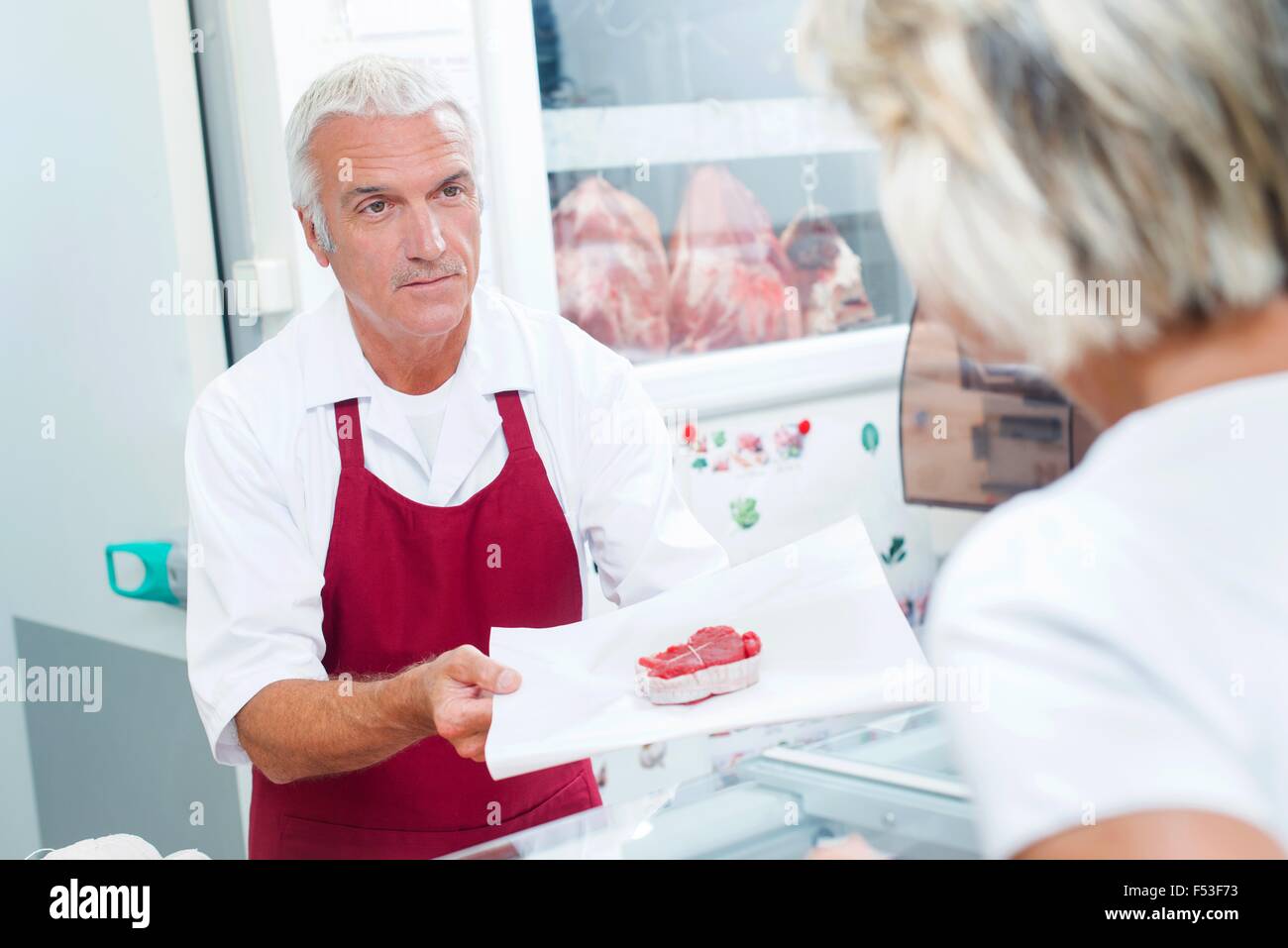 Butcher preparing a cut of meat Stock Photo - Alamy