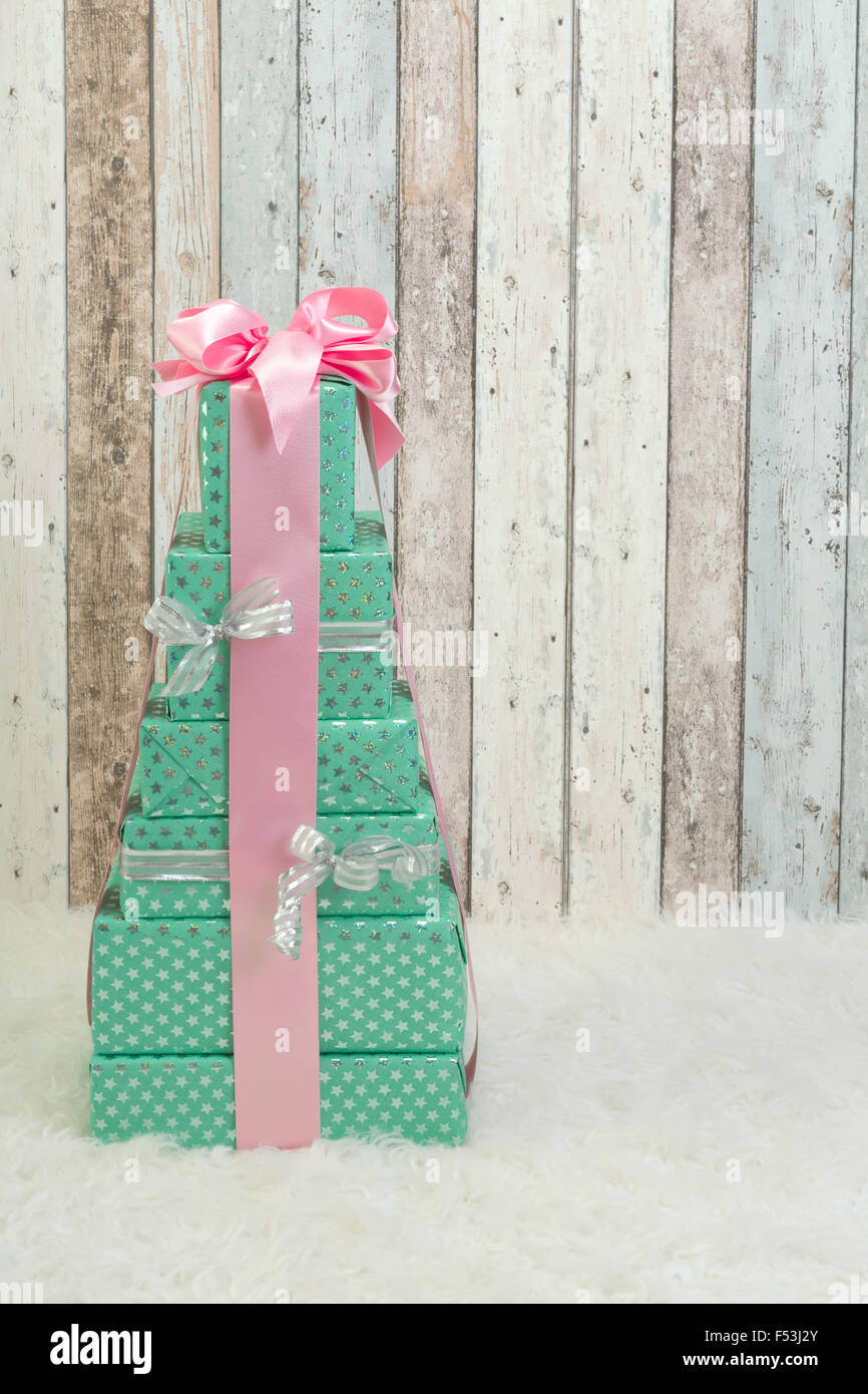 Stack of six christmas presents wrapped in a pink bow Stock Photo - Alamy