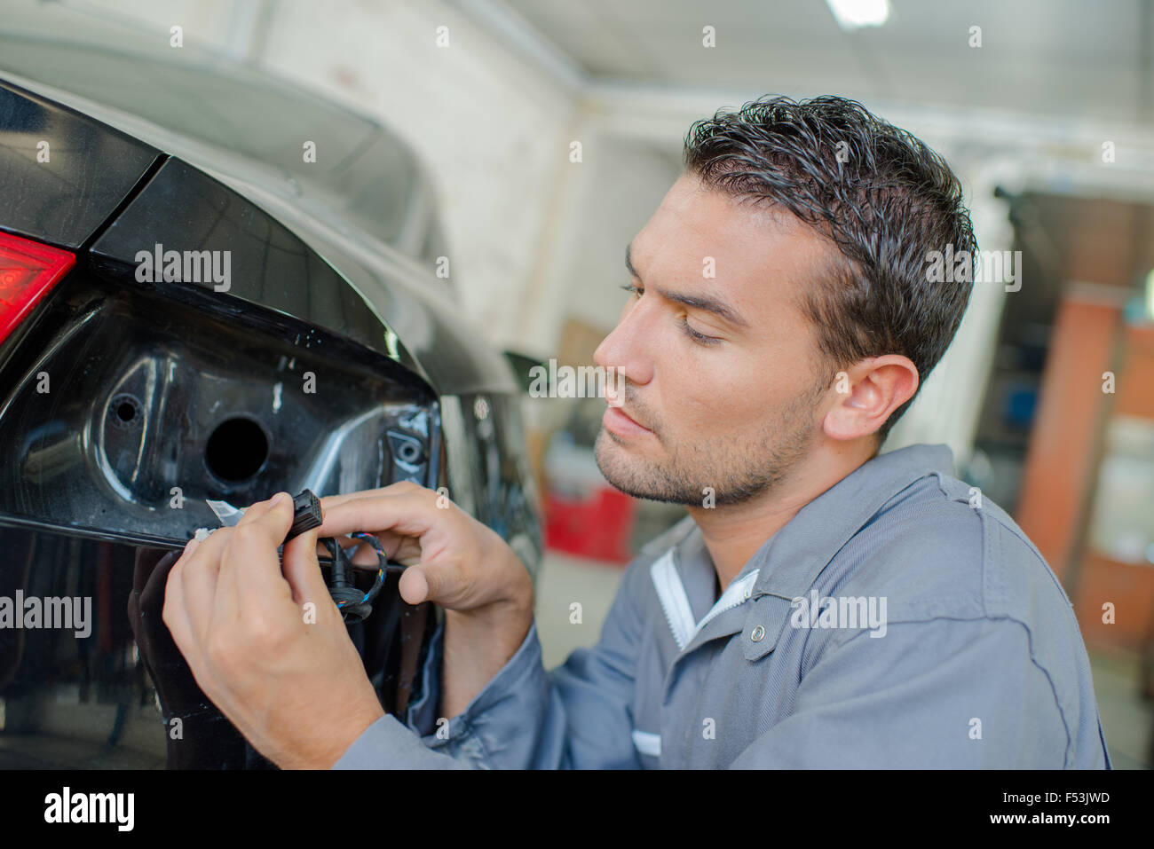 Mechanic changing a bulb Stock Photo - Alamy