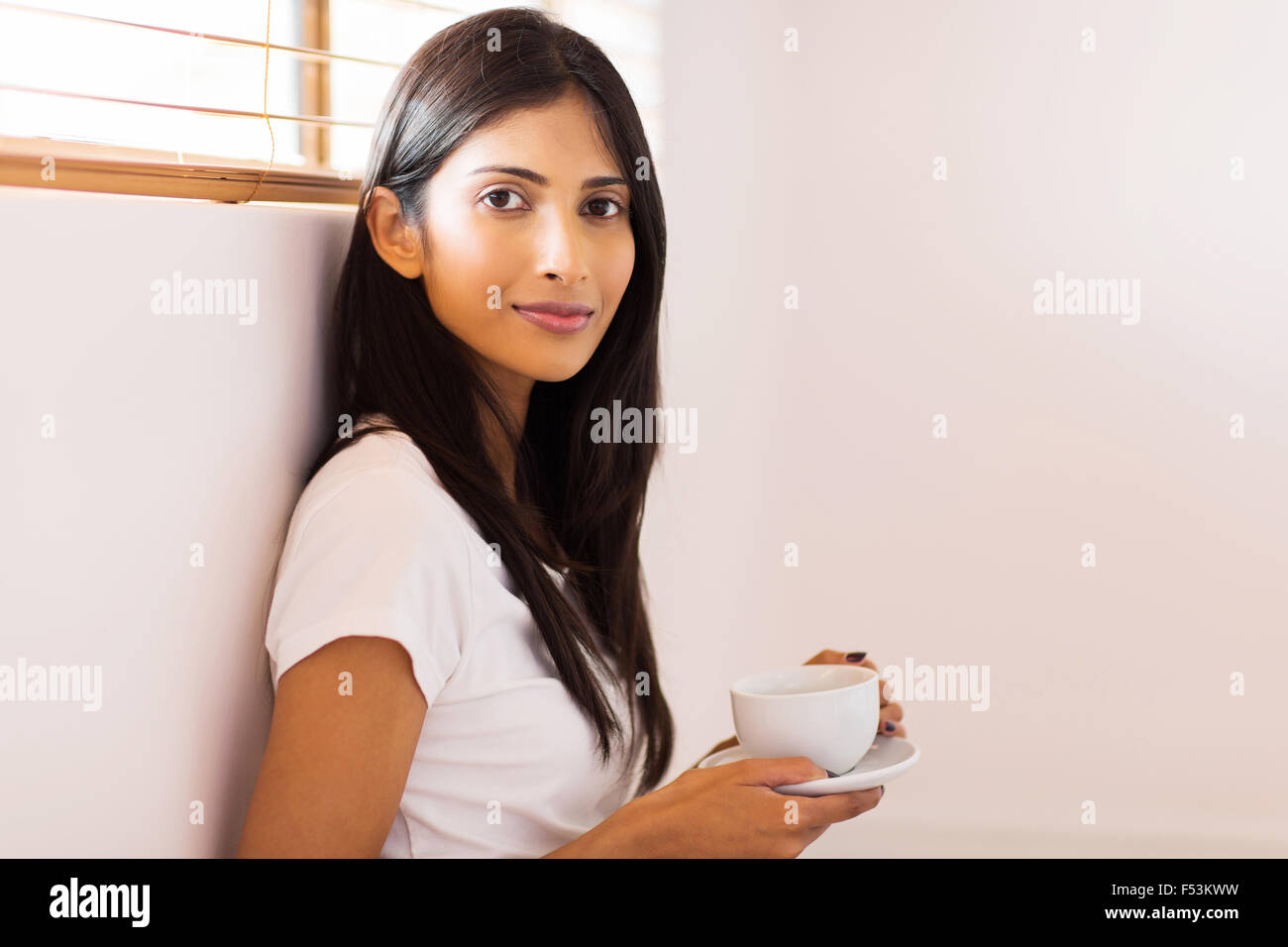 attractive young Indian woman drinking tea at home Stock Photo - Alamy