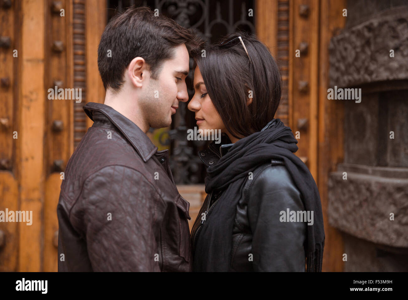 Portrait of a beautiful romantic couple flirting outdoors Stock Photo ...